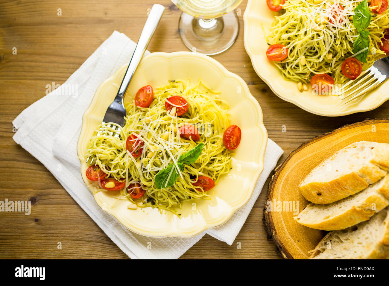 Homemade angel hair pasta with pesto sauce and roasted cherry tomatoes ...