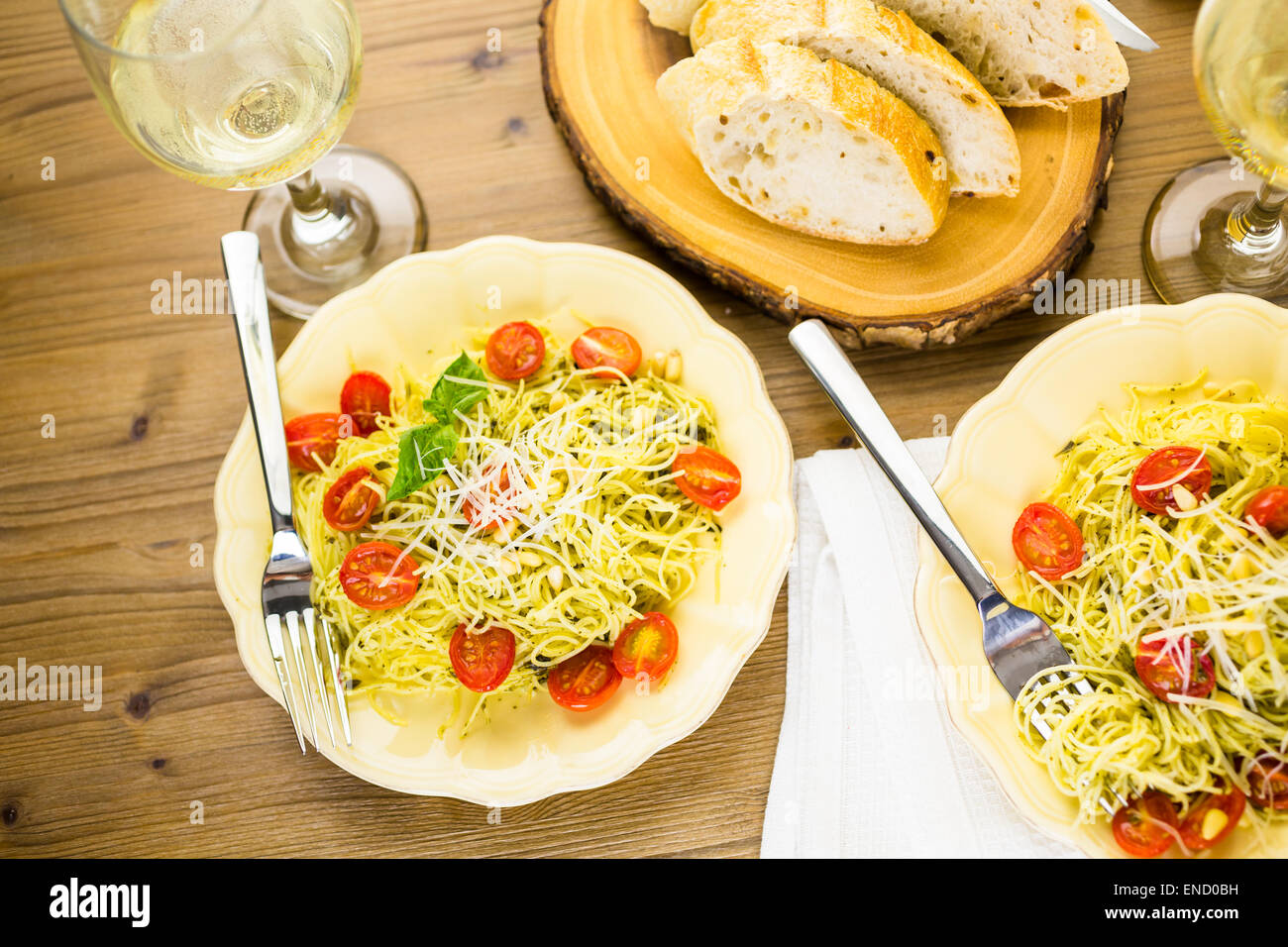 Homemade angel hair pasta with pesto sauce and roasted cherry tomatoes ...