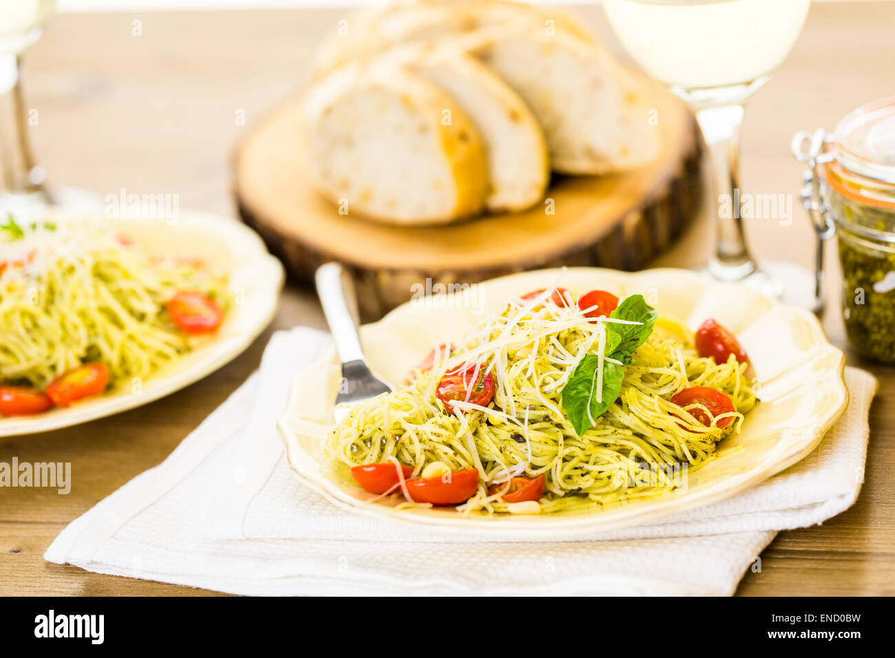 Homemade angel hair pasta with pesto sauce and roasted cherry tomatoes ...