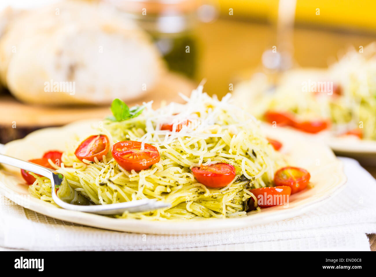 Homemade angel hair pasta with pesto sauce and roasted cherry tomatoes ...