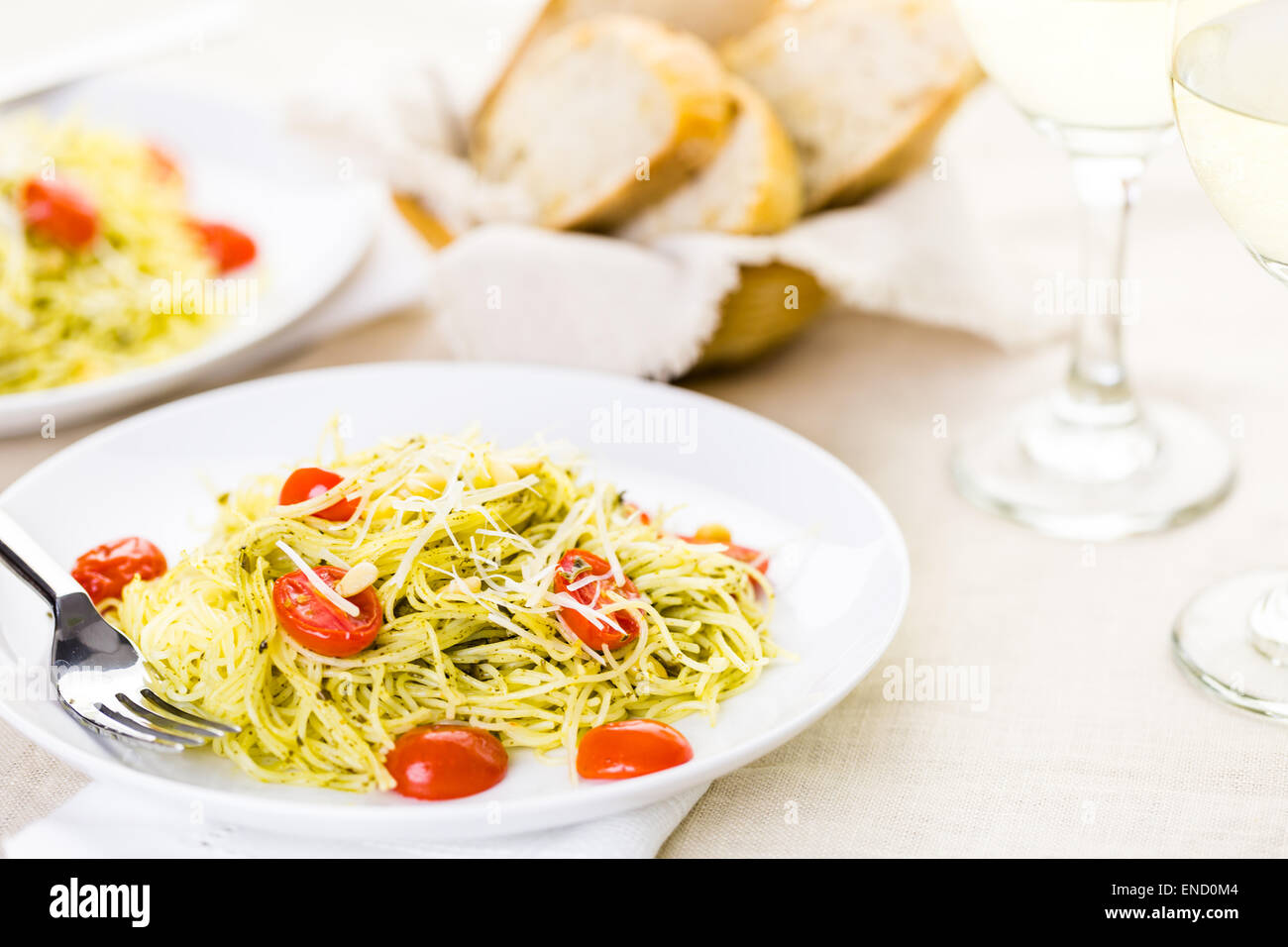 Homemade angel hair pasta with pesto sauce and roasted cherry tomatoes ...