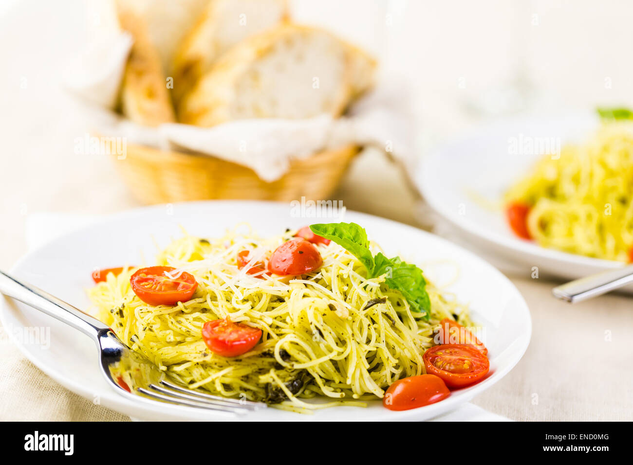 Homemade angel hair pasta with pesto sauce and roasted cherry tomatoes ...