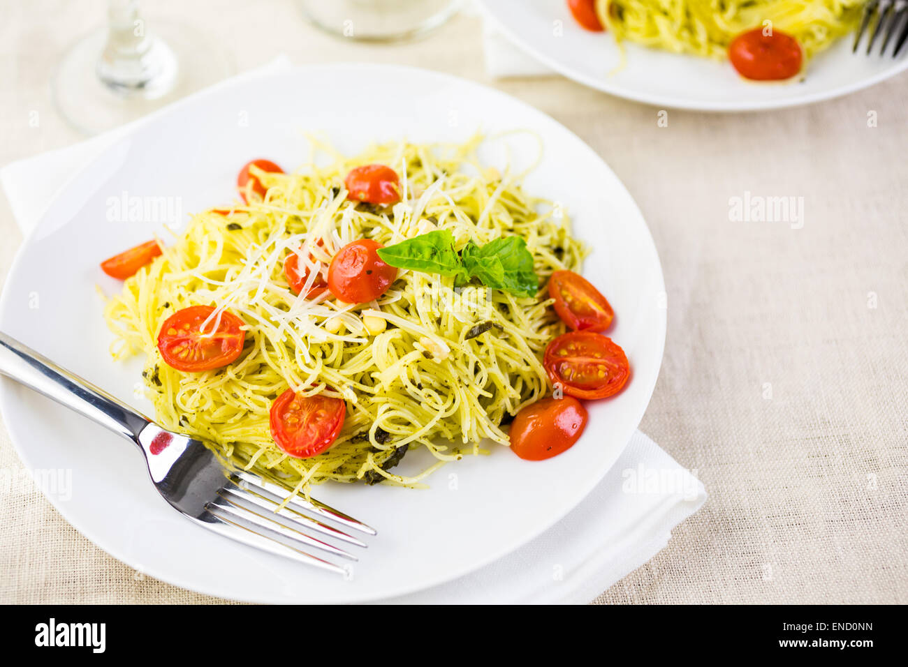 Homemade angel hair pasta with pesto sauce and roasted cherry tomatoes ...