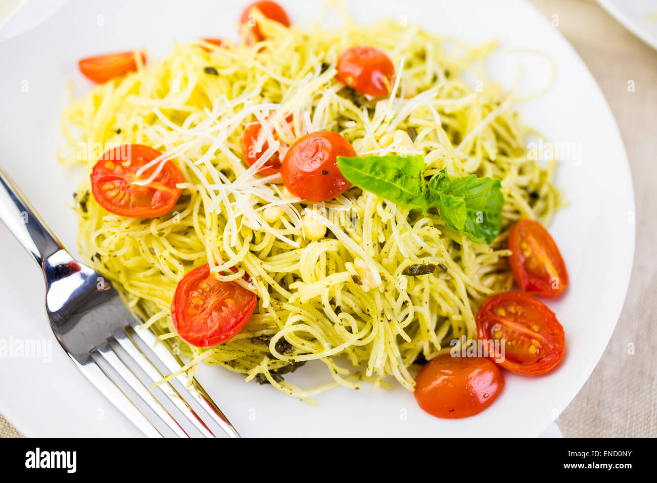 Homemade angel hair pasta with pesto sauce and roasted cherry tomatoes ...