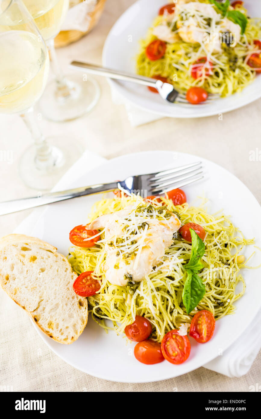 Homemade angel hair pasta with pesto sauce, roasted cherry tomatoes and ...