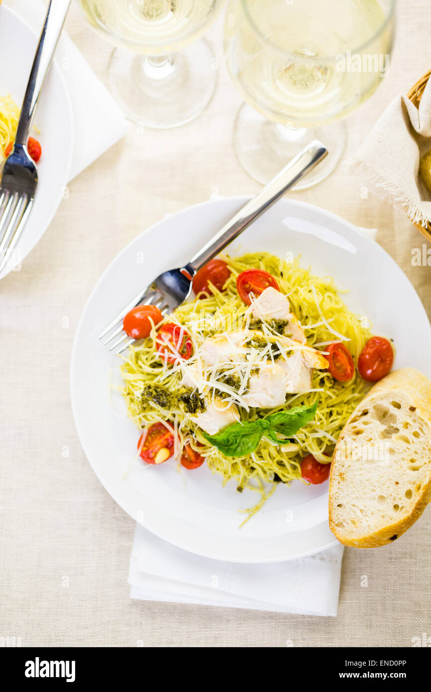 Homemade angel hair pasta with pesto sauce, roasted cherry tomatoes and ...