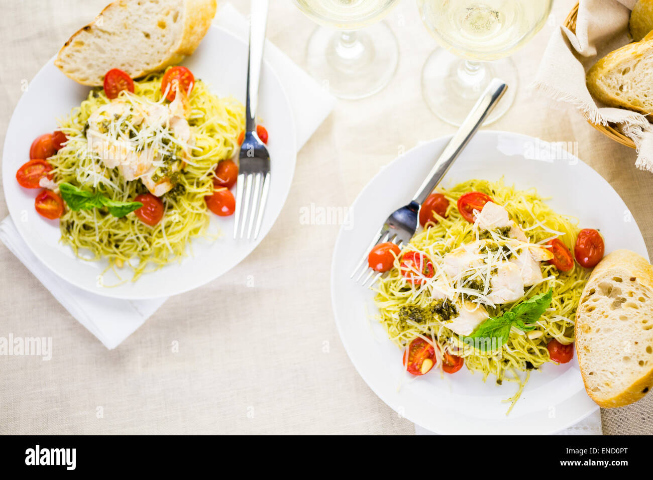 Homemade angel hair pasta with pesto sauce, roasted cherry tomatoes and ...