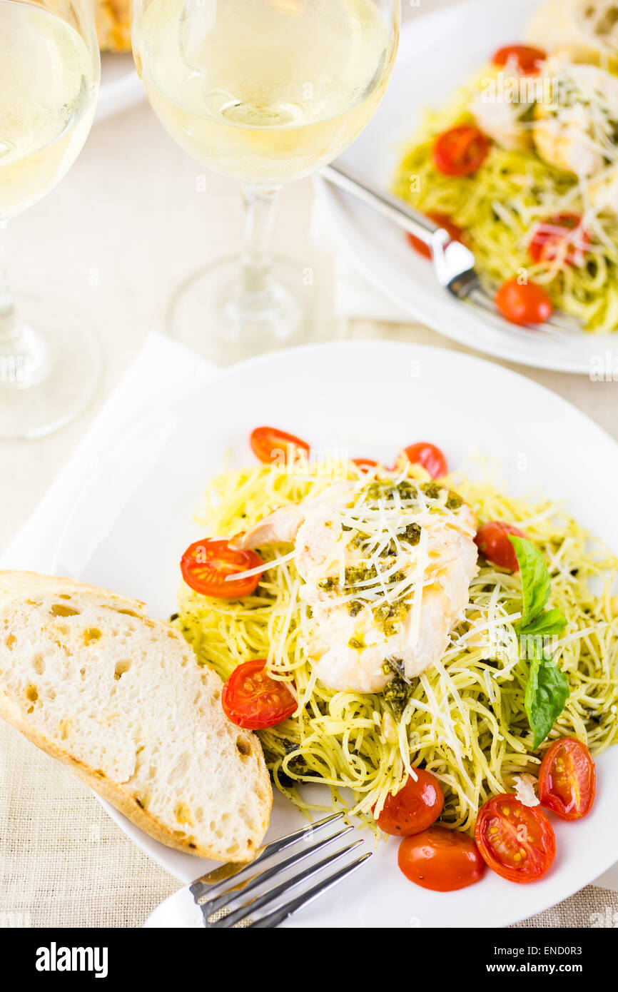 Homemade angel hair pasta with pesto sauce, roasted cherry tomatoes and ...