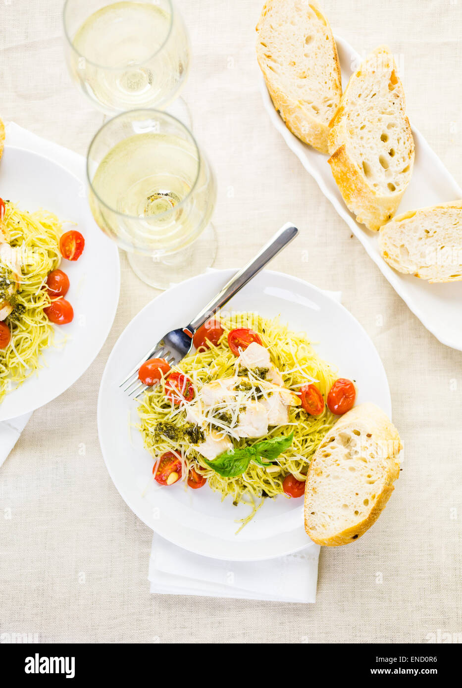 Homemade angel hair pasta with pesto sauce, roasted cherry tomatoes and ...
