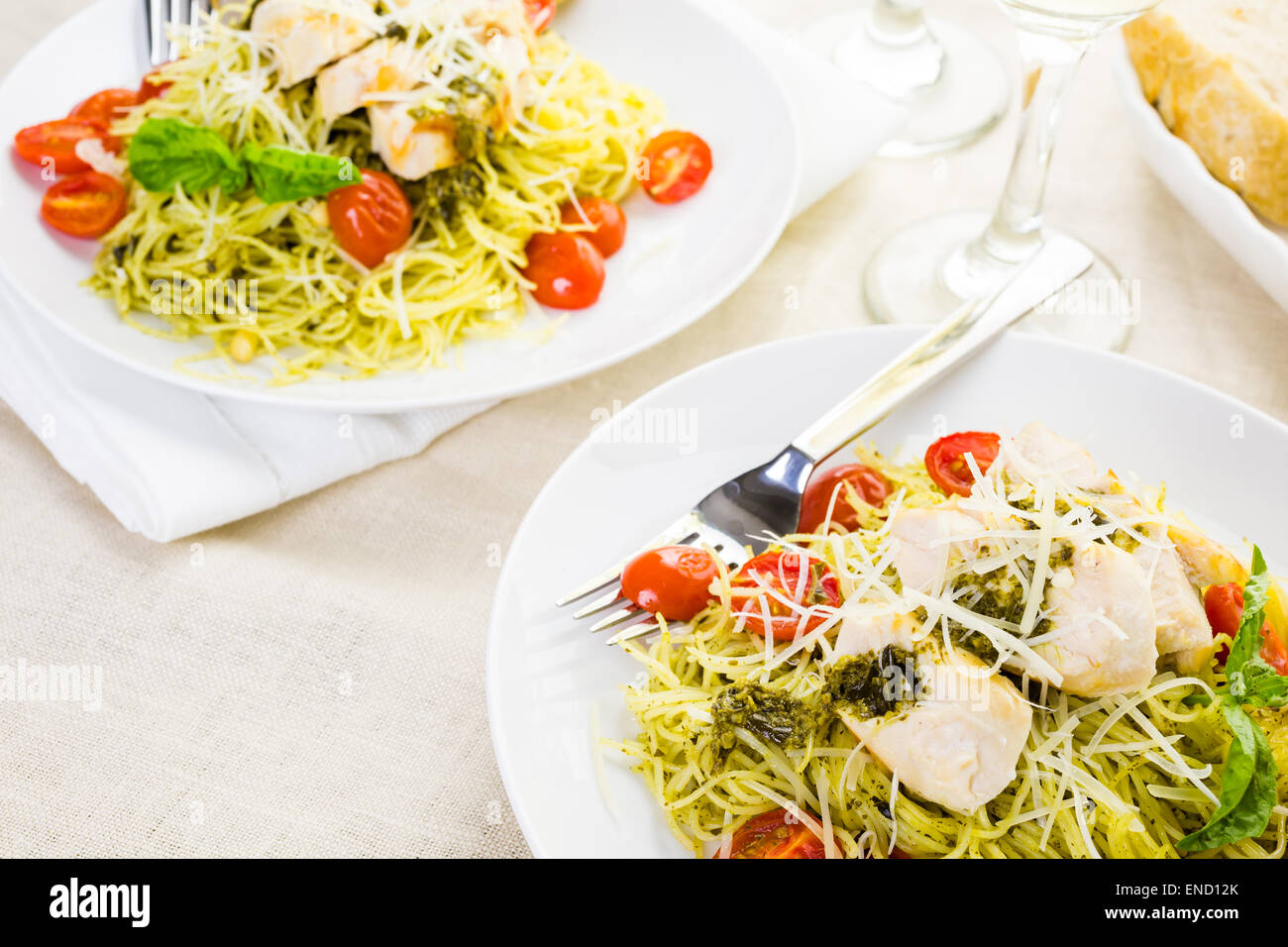 Homemade angel hair pasta with pesto sauce, roasted cherry tomatoes and ...