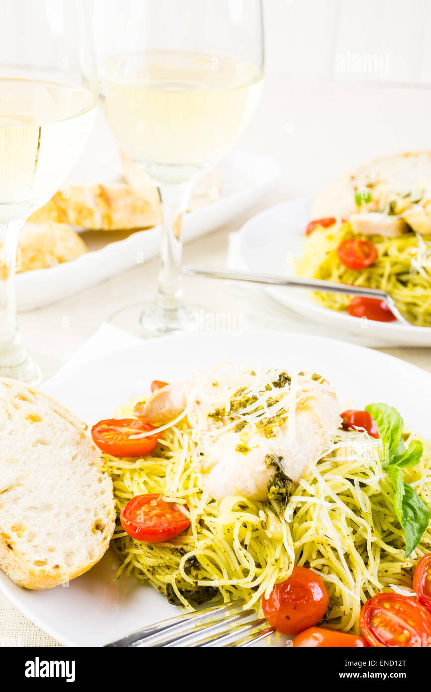 Homemade angel hair pasta with pesto sauce, roasted cherry tomatoes and ...