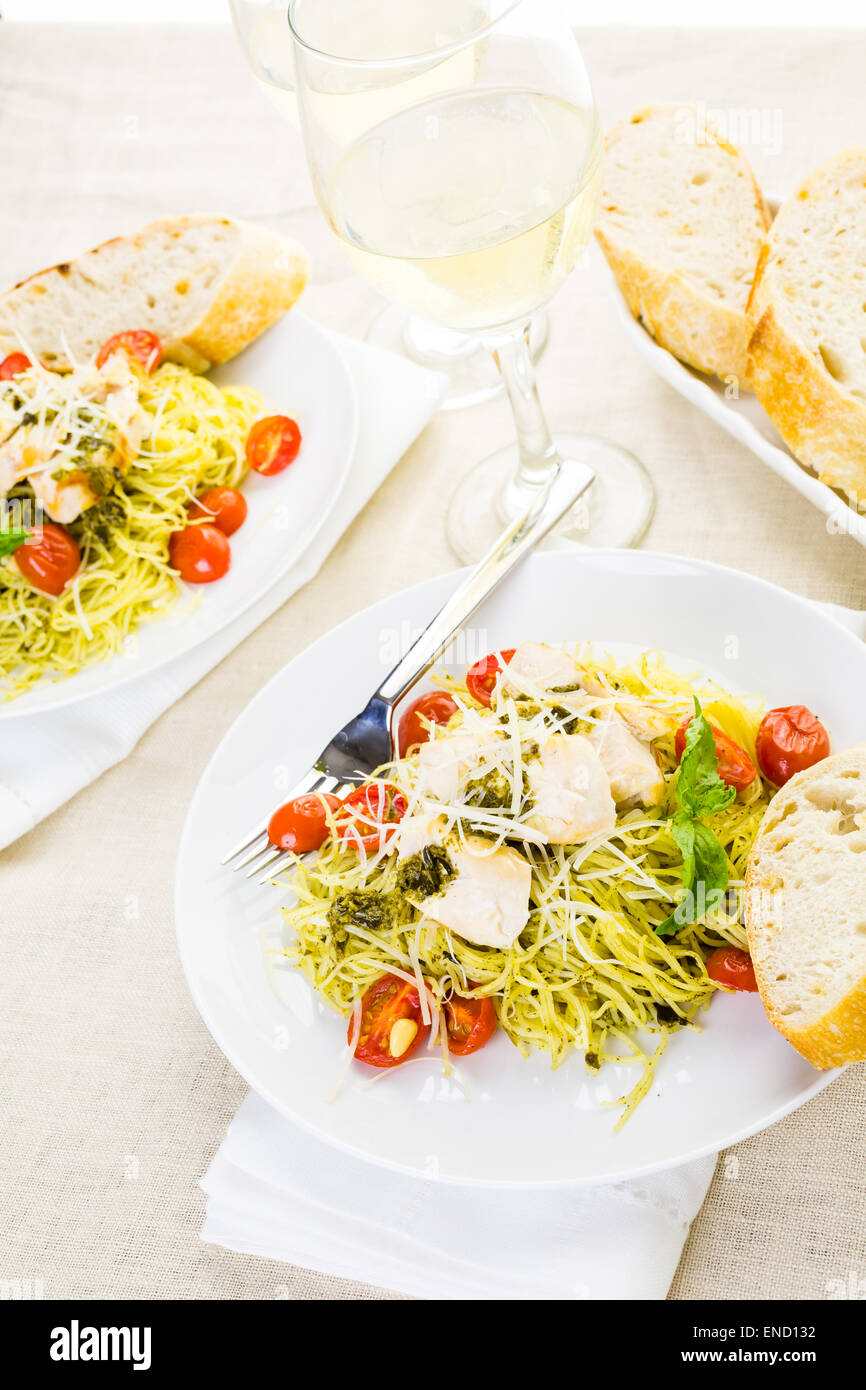 Homemade angel hair pasta with pesto sauce, roasted cherry tomatoes and ...