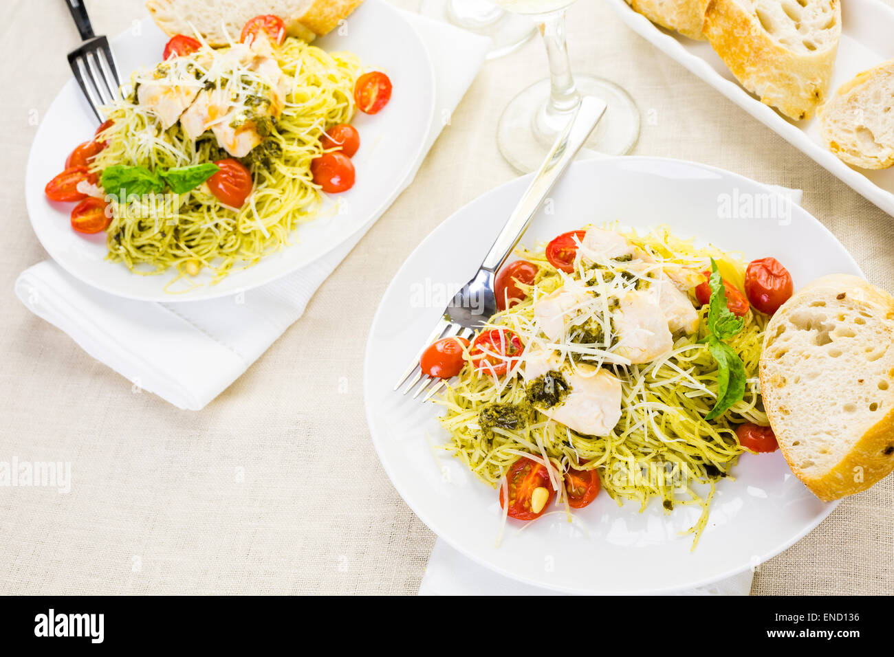 Homemade angel hair pasta with pesto sauce, roasted cherry tomatoes and ...