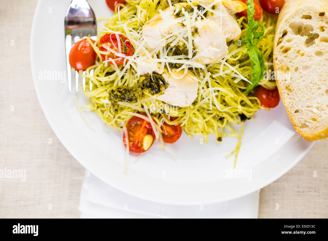 Homemade angel hair pasta with pesto sauce, roasted cherry tomatoes and ...
