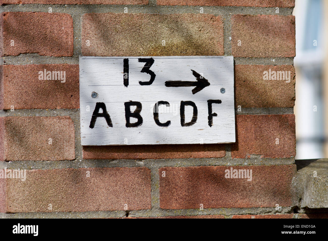 Handmade sign showing house number 13 and flats A B C D and F Stock ...