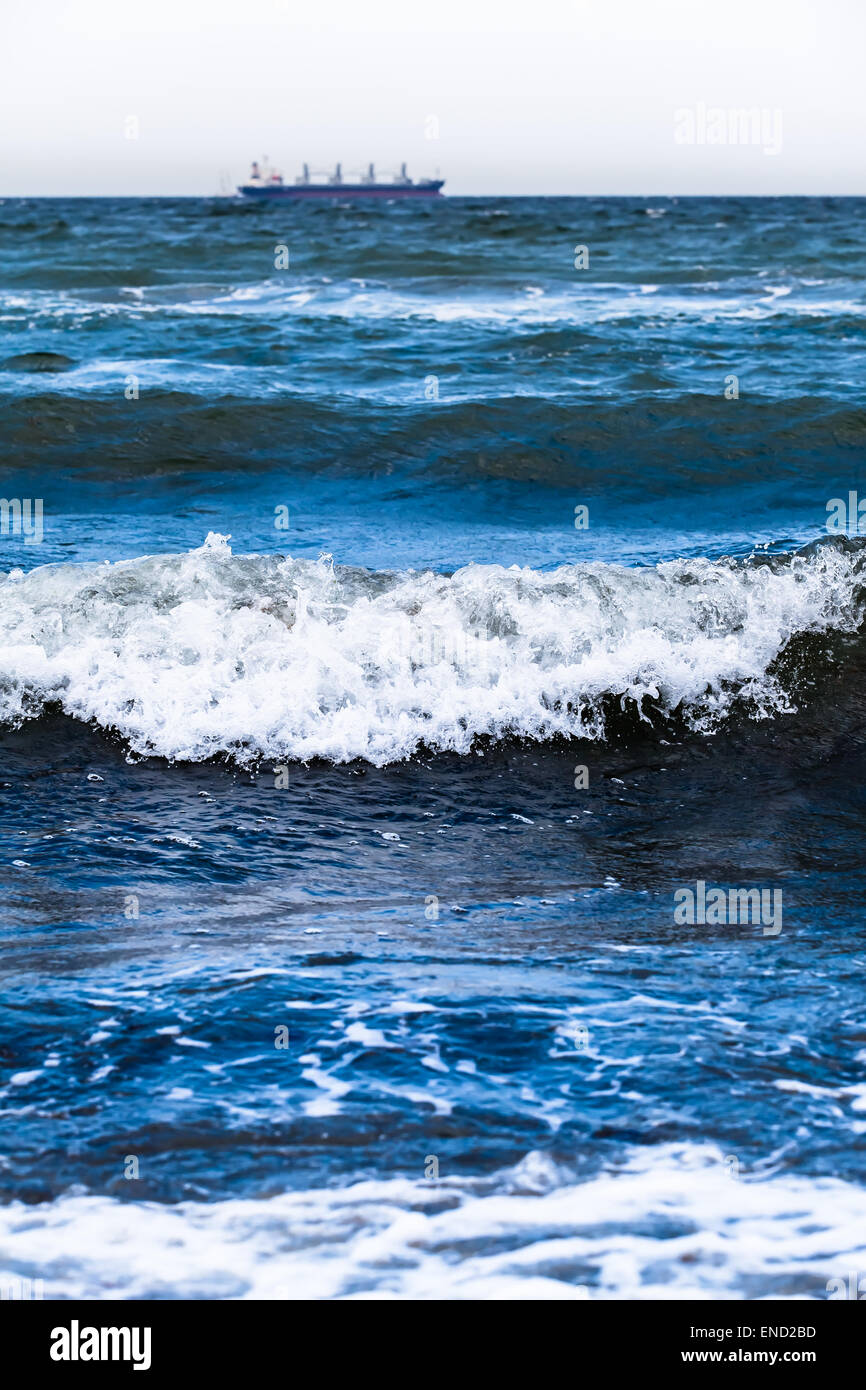 Shore waves and a far away vessel at the rough sea Stock Photo - Alamy