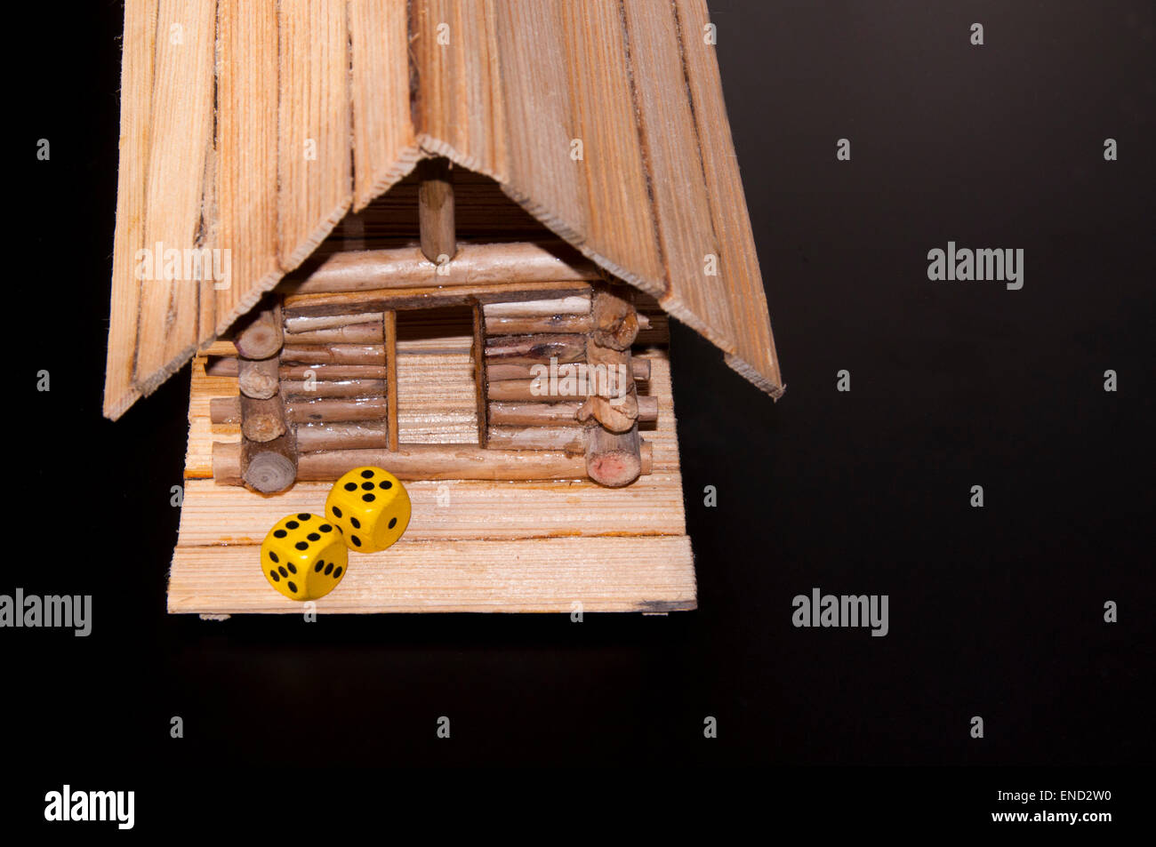 Little wooden house with 2 dice in front, conceptual image about ...