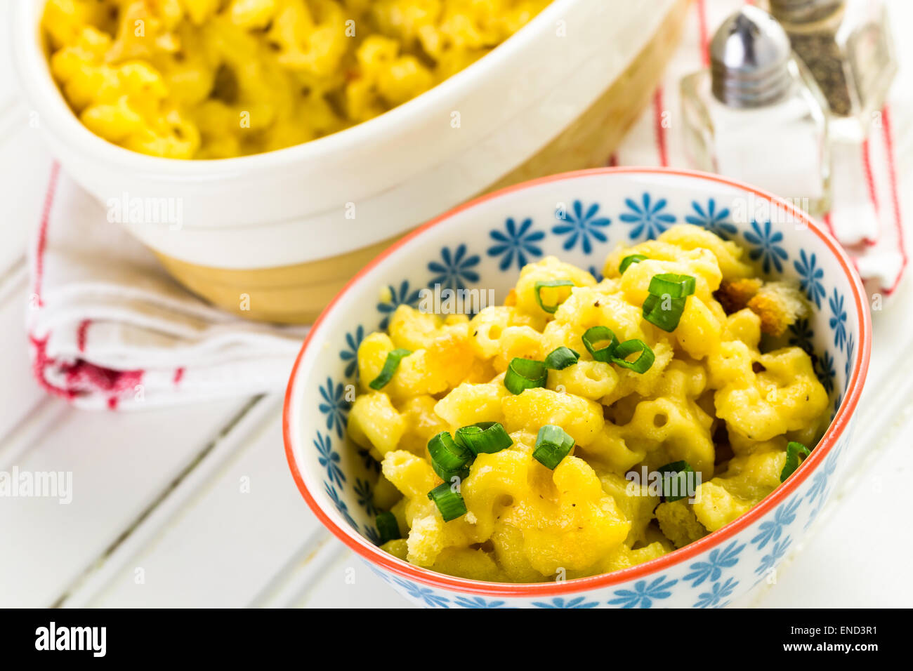 Baked macaroni and cheese with bead rumbs and garnished with chives ...