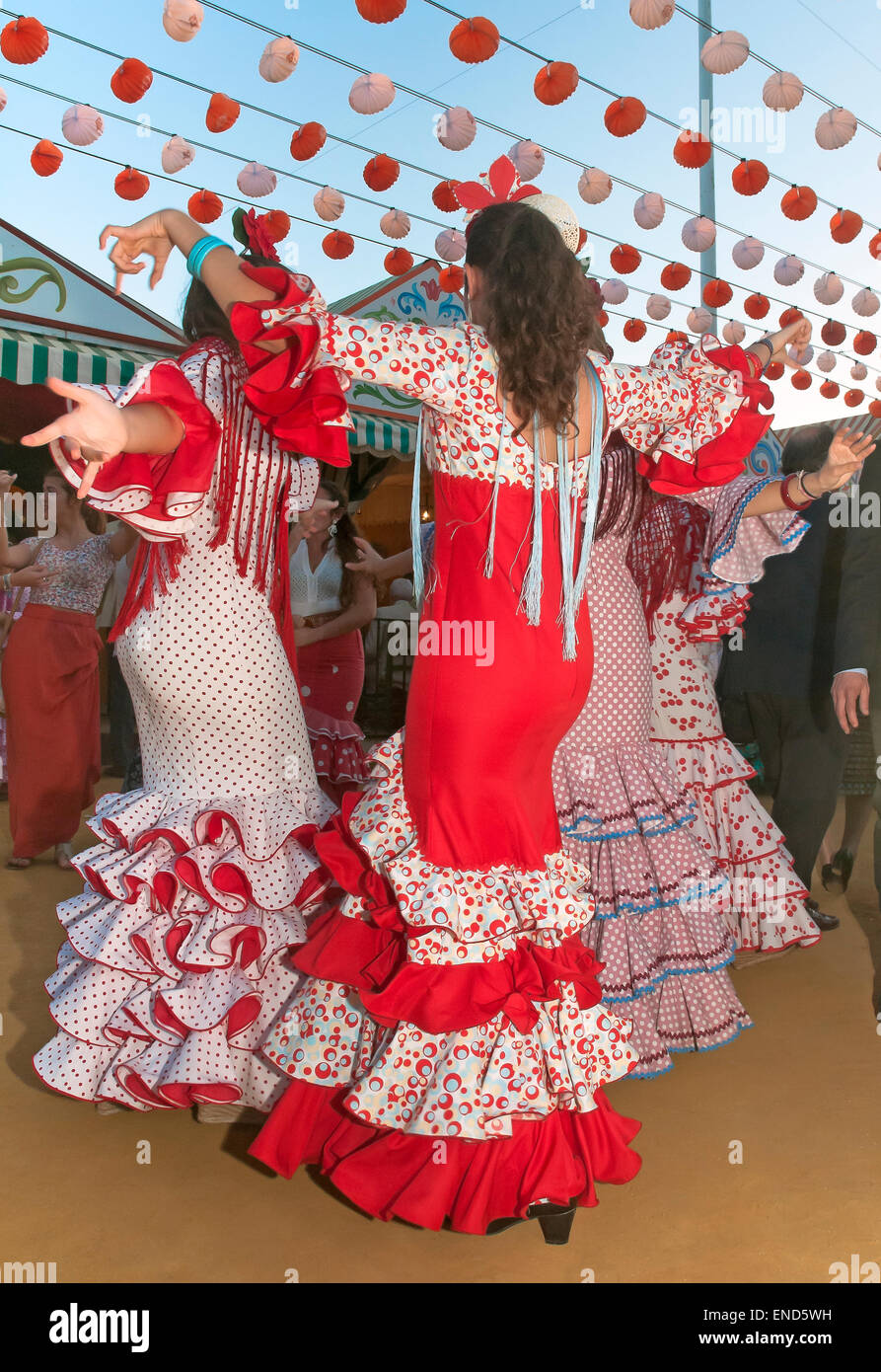 April Fair, Young women dancing with the traditional flamenco dress ...