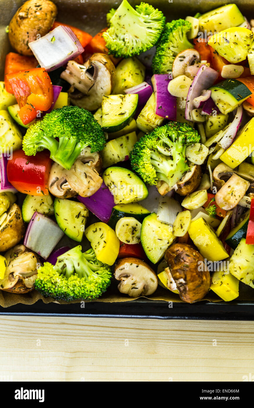Preparing fresh roasted mixed vegetables for dinner Stock Photo - Alamy