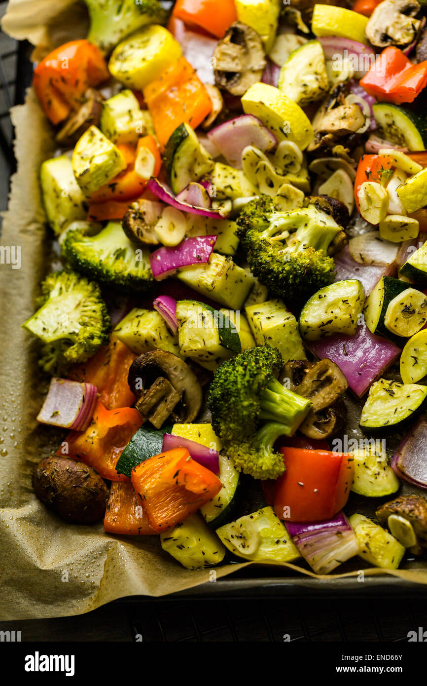 Preparing fresh roasted mixed vegetables for dinner Stock Photo - Alamy