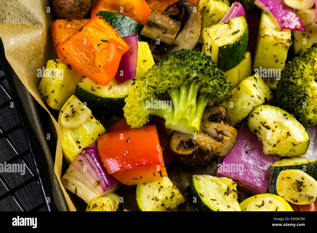 Preparing fresh roasted mixed vegetables for dinner Stock Photo - Alamy