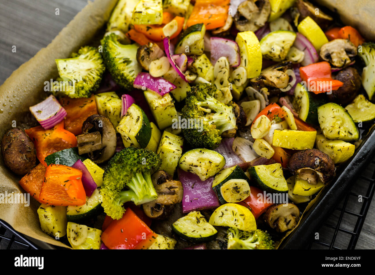 Preparing fresh roasted mixed vegetables for dinner Stock Photo - Alamy
