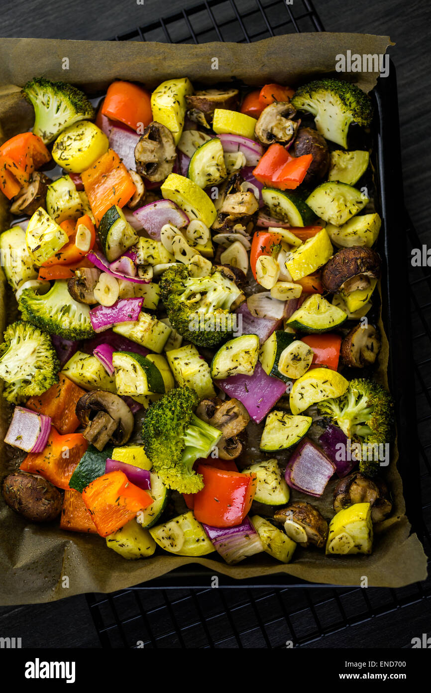 Preparing fresh roasted mixed vegetables for dinner Stock Photo - Alamy