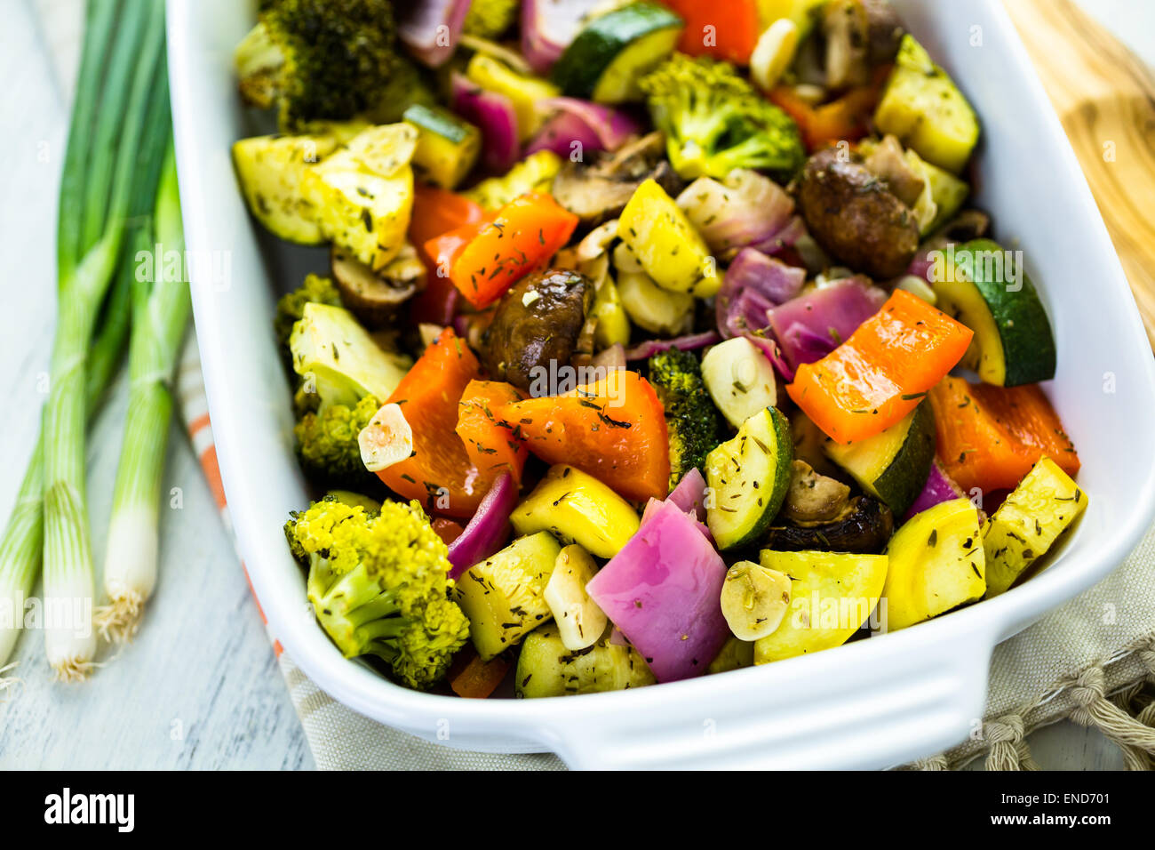 Preparing fresh roasted mixed vegetables for dinner Stock Photo - Alamy