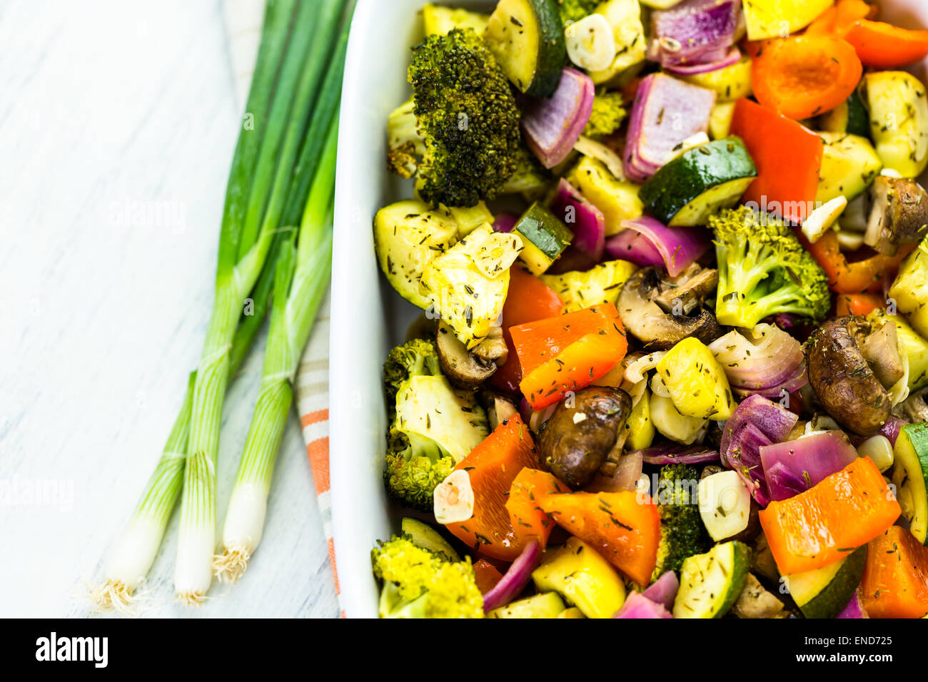 Preparing fresh roasted mixed vegetables for dinner Stock Photo - Alamy