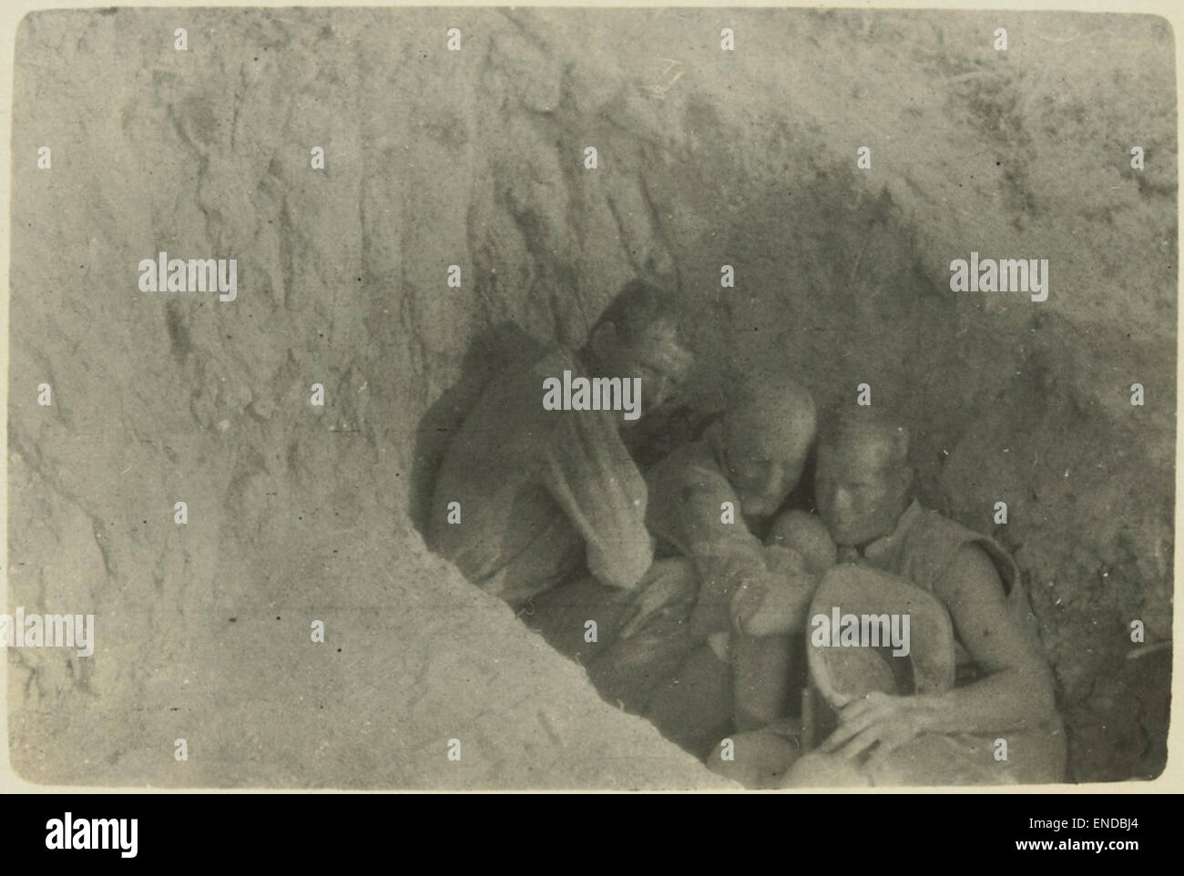 Sheltering from bursting shells, [showing three Anzac soldiers huddled ...