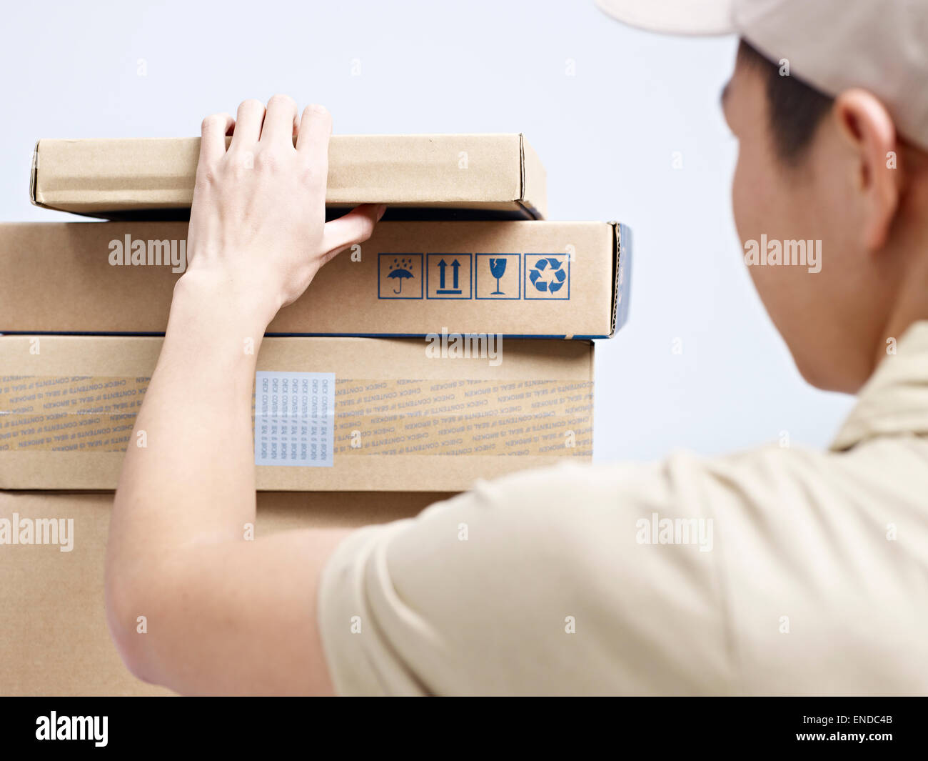 delivery man checking packages in store room Stock Photo - Alamy