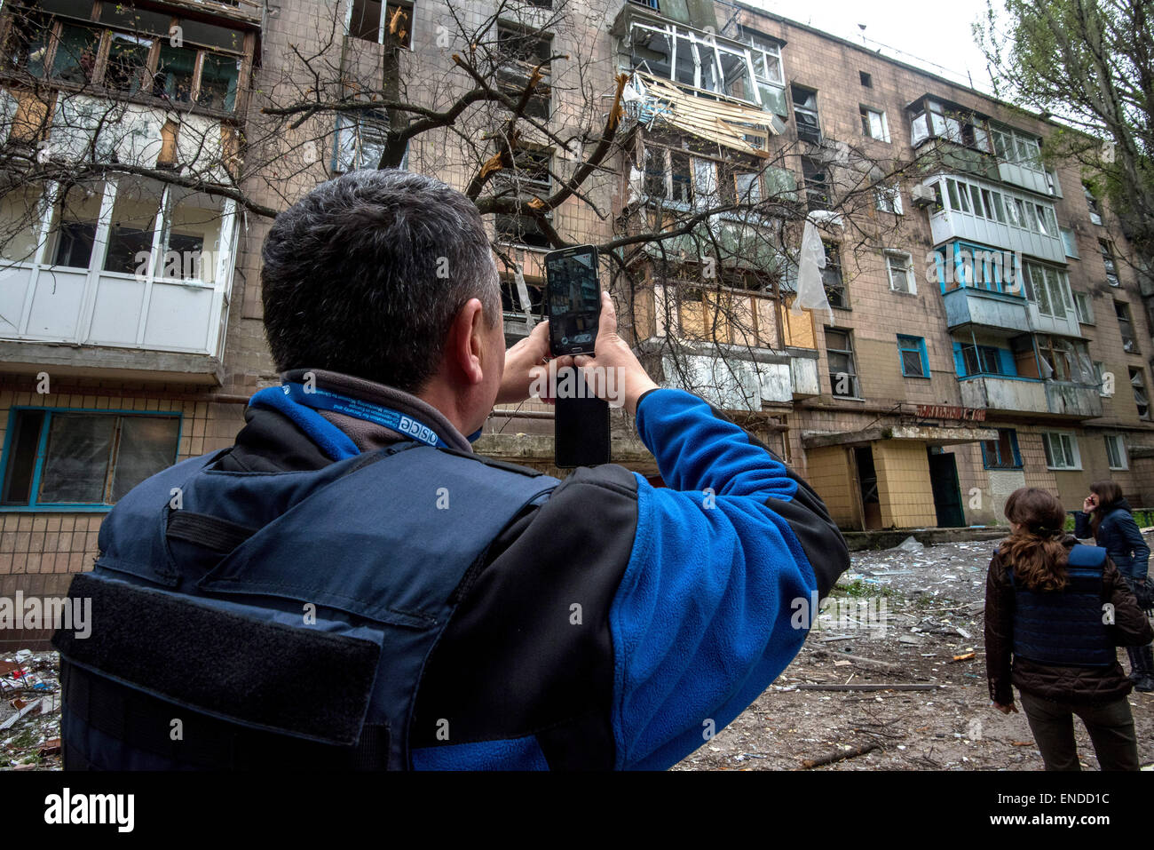 Donetsk, Ukraine, 03 May 2015. An OSCE observer photographs the damage ...