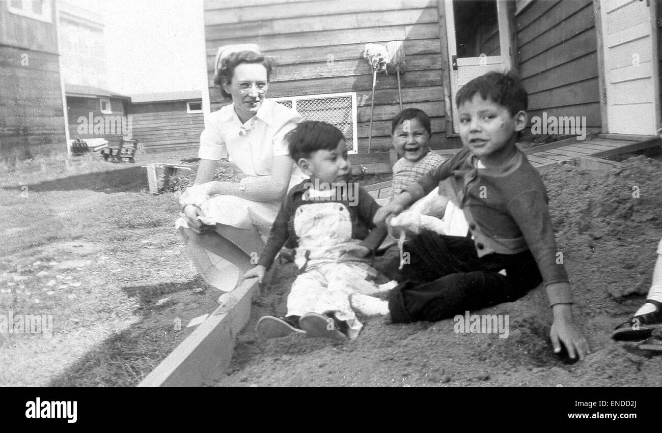This photograph features four individuals: Miss Taylor, Johnny Laboucan ...