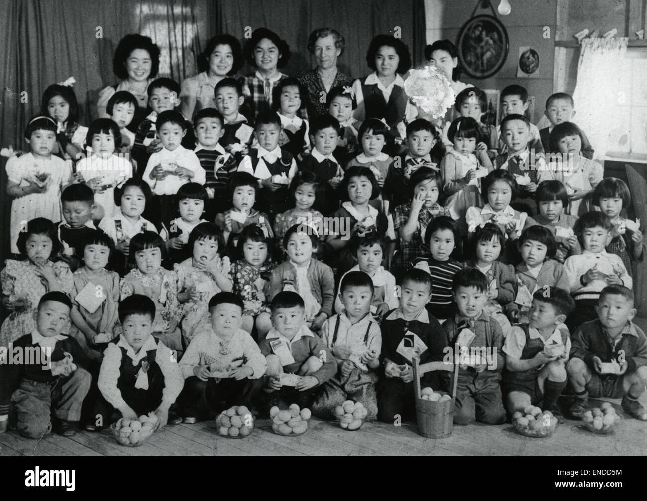 This historical photograph likely depicts a group of Japanese-American ...