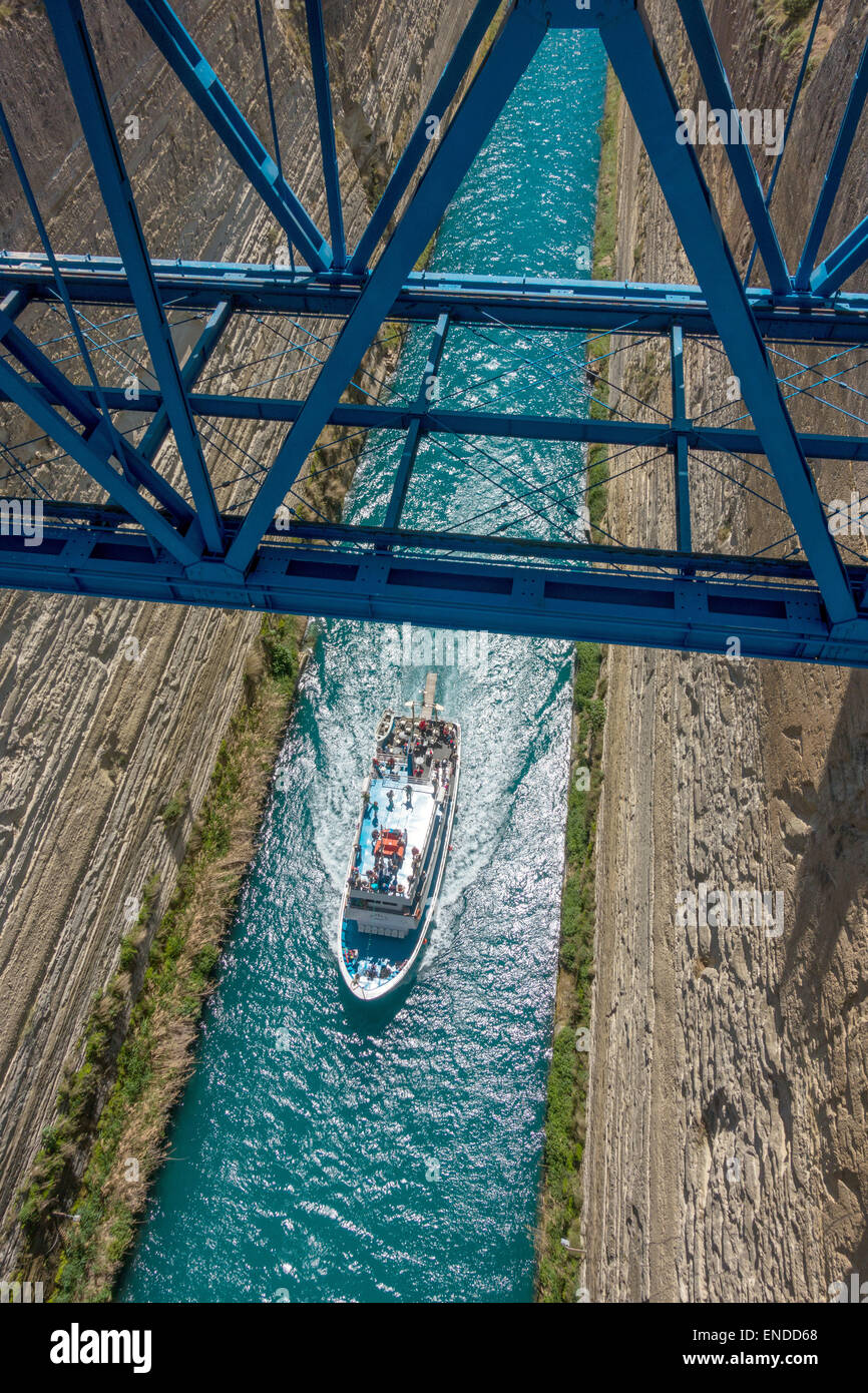 The Corinth Canal with tourist boat seen from above with railway bridge ...