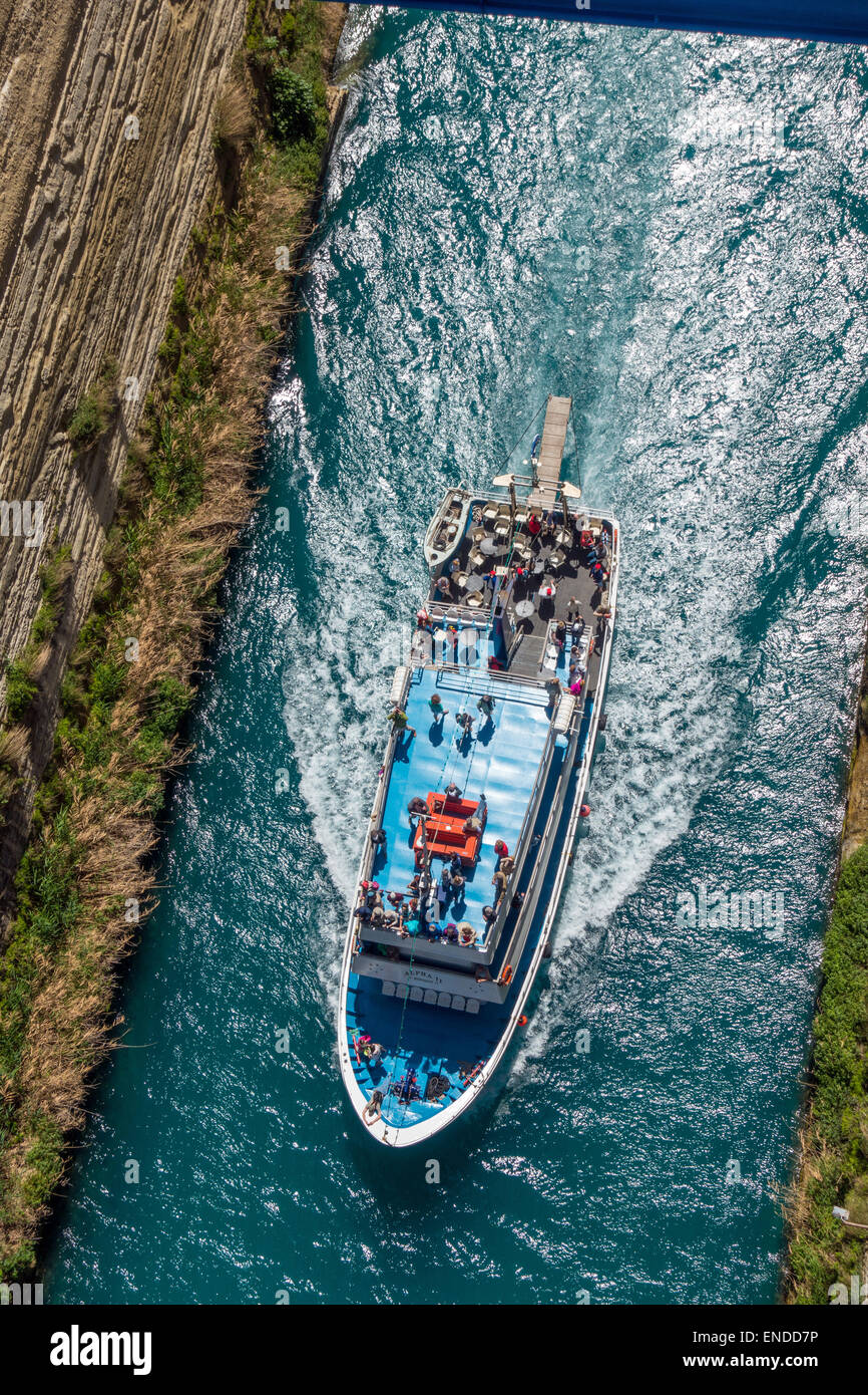 The Corinth Canal with tourist boat seen from above with railway bridge ...