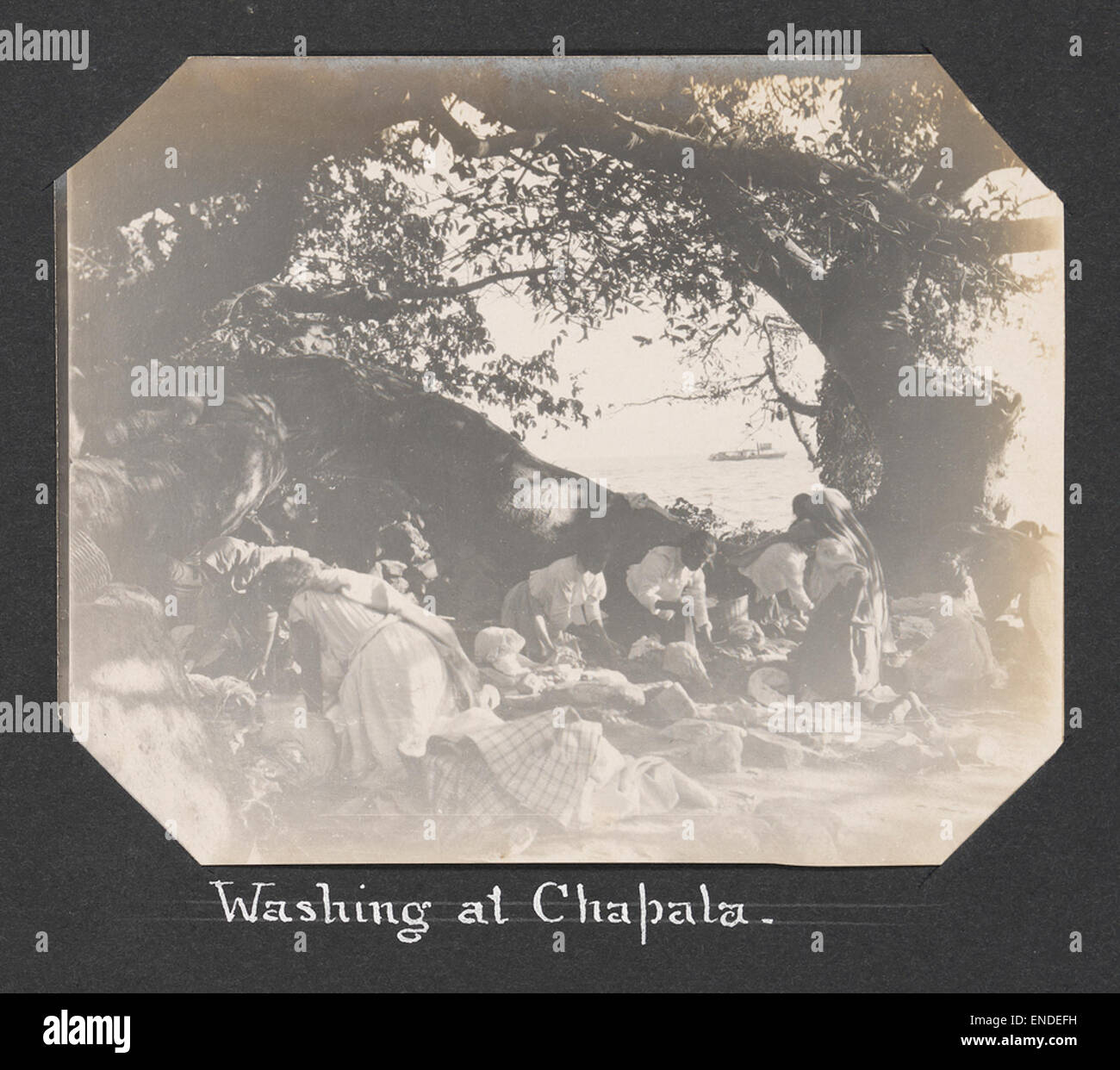 This photograph captures the traditional practice of washing clothes at ...