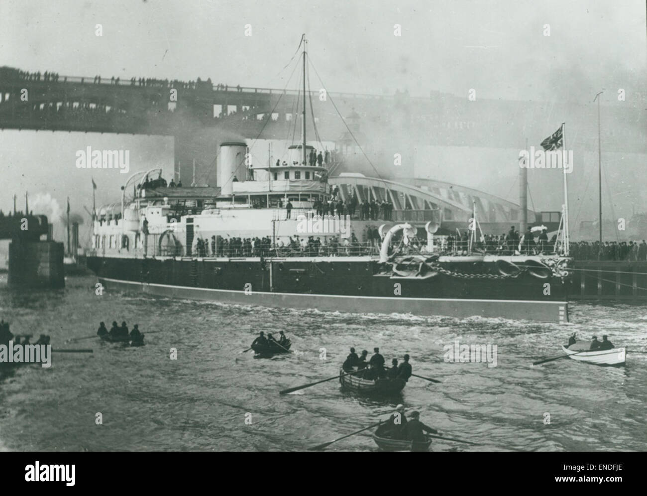 A photograph of HMS Victoria, a Royal Navy battleship, passing under ...