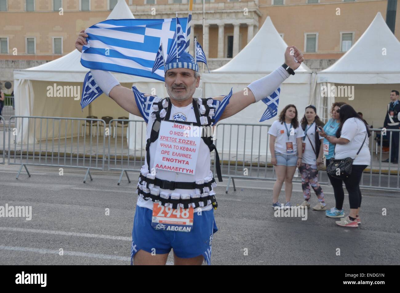 Athens, Greece. 03rd May, 2015. A marathon runner carrying many Greek ...