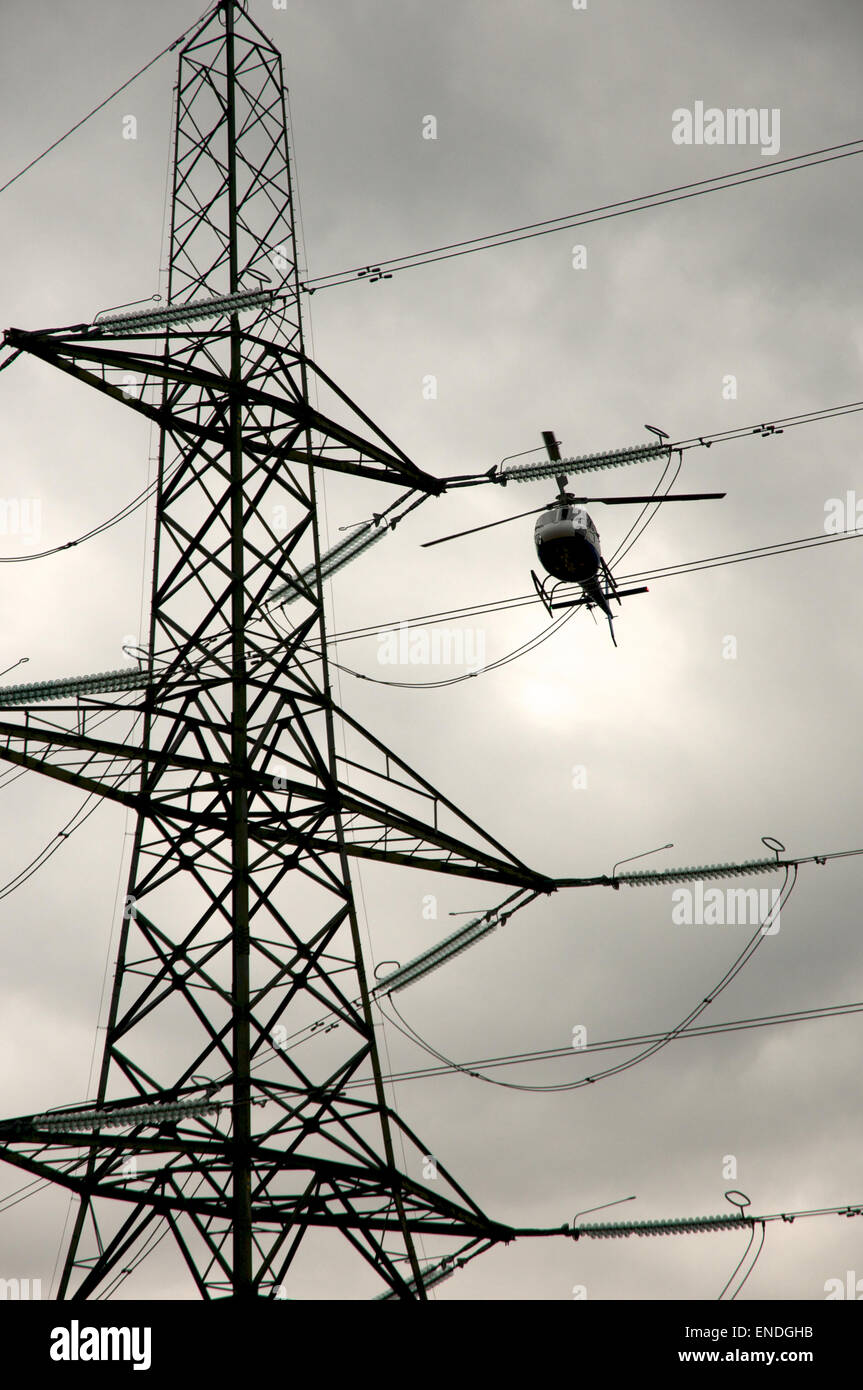 Helicopter inspecting power lines Stock Photo - Alamy