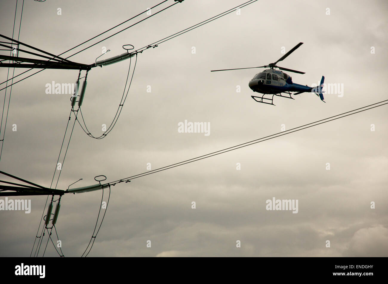 Helicopter inspecting power lines Stock Photo - Alamy