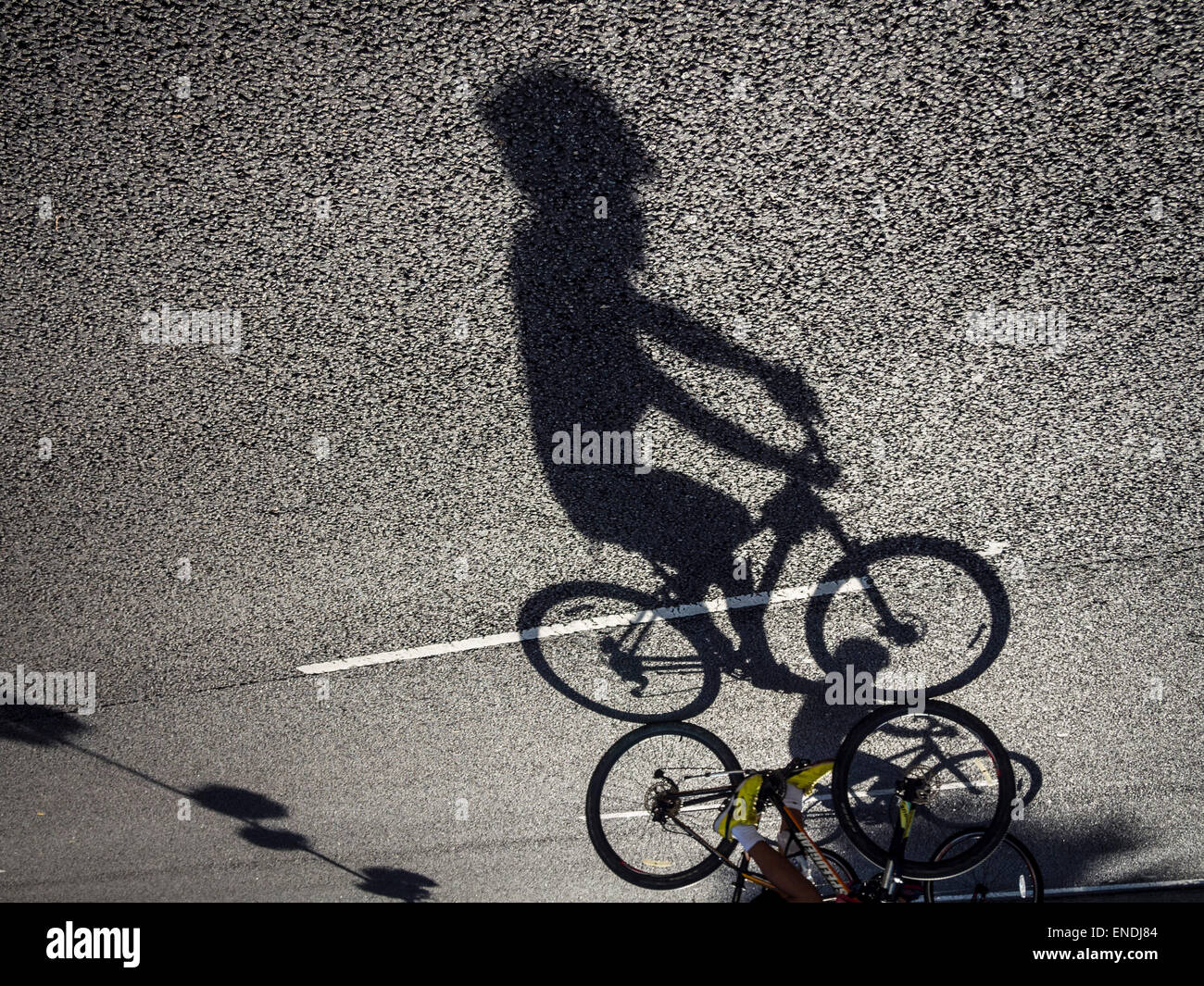 Upside down image of the shadow of a cyclist Stock Photo - Alamy