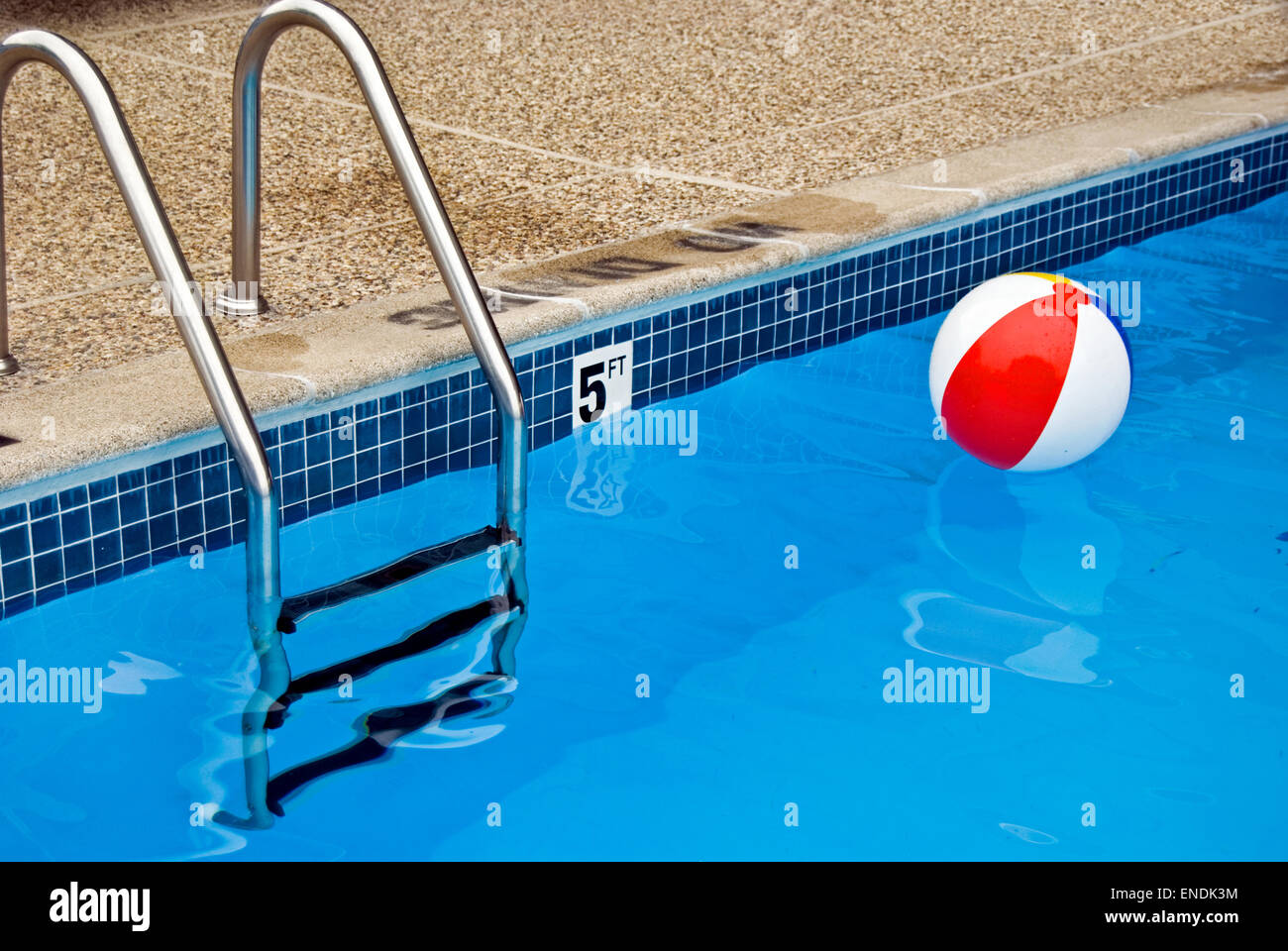 Inflatable beach ball floating in swimming pool Stock Photo - Alamy