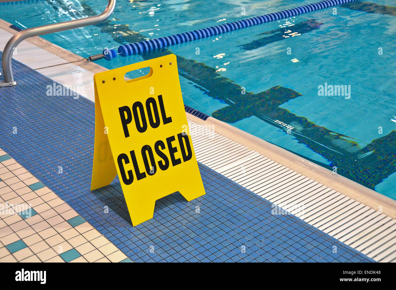Bright yellow warning sign at the edge of a swimming pool Stock Photo ...
