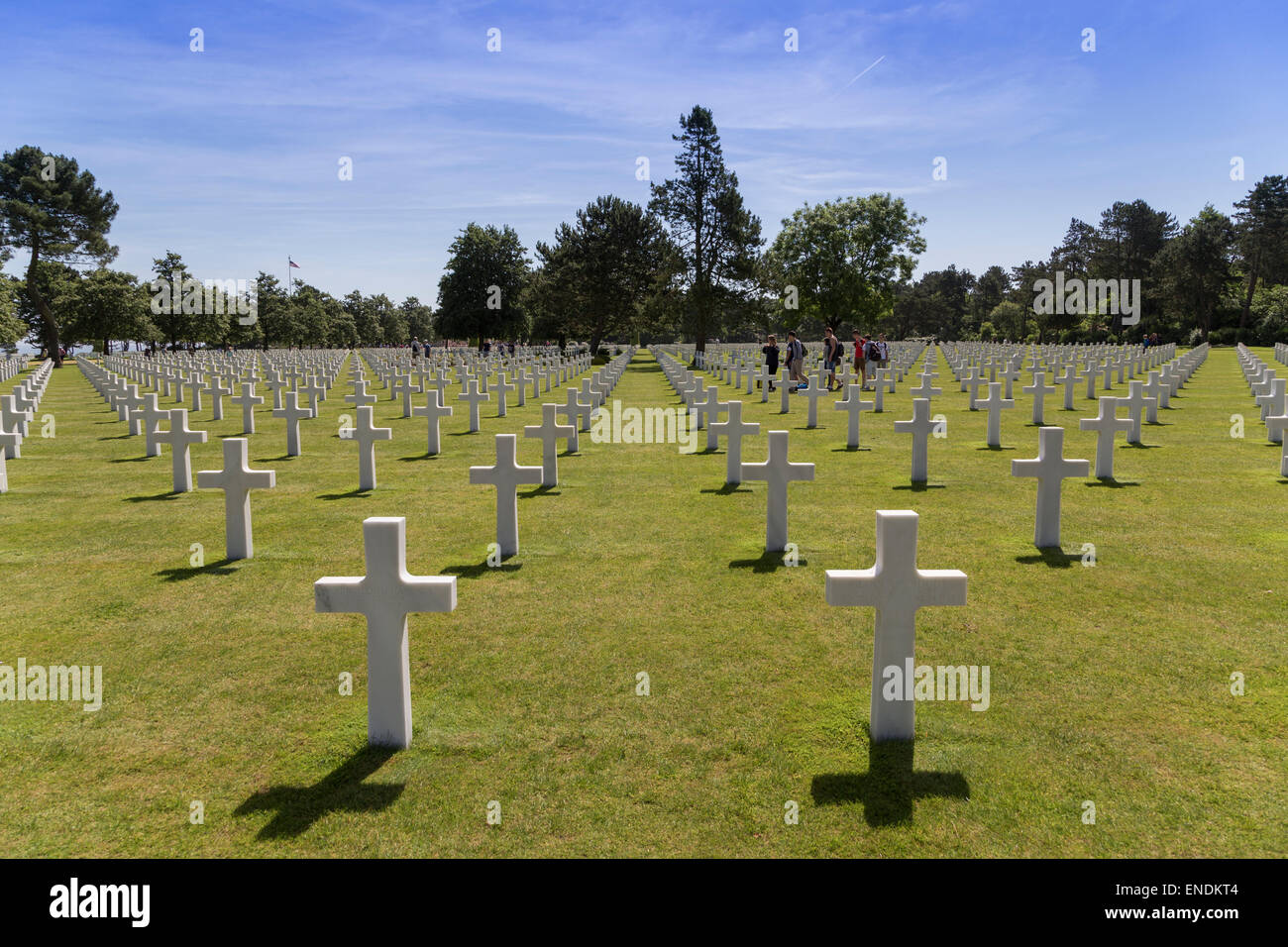 D-Day American Cemetery White Crosses in symmetrical rows with visitors ...