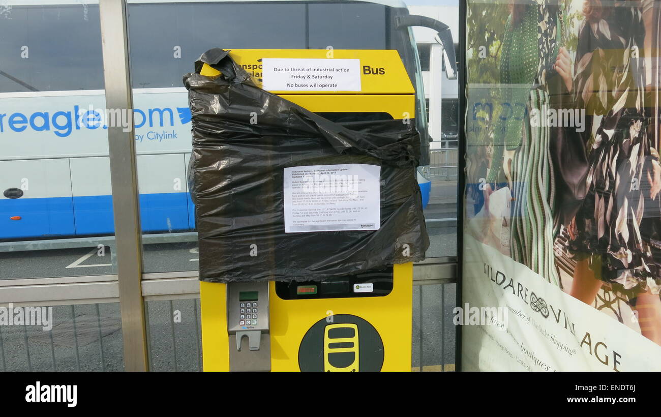 A sign notifying of strike action on a ticket machine at an empty bus ...