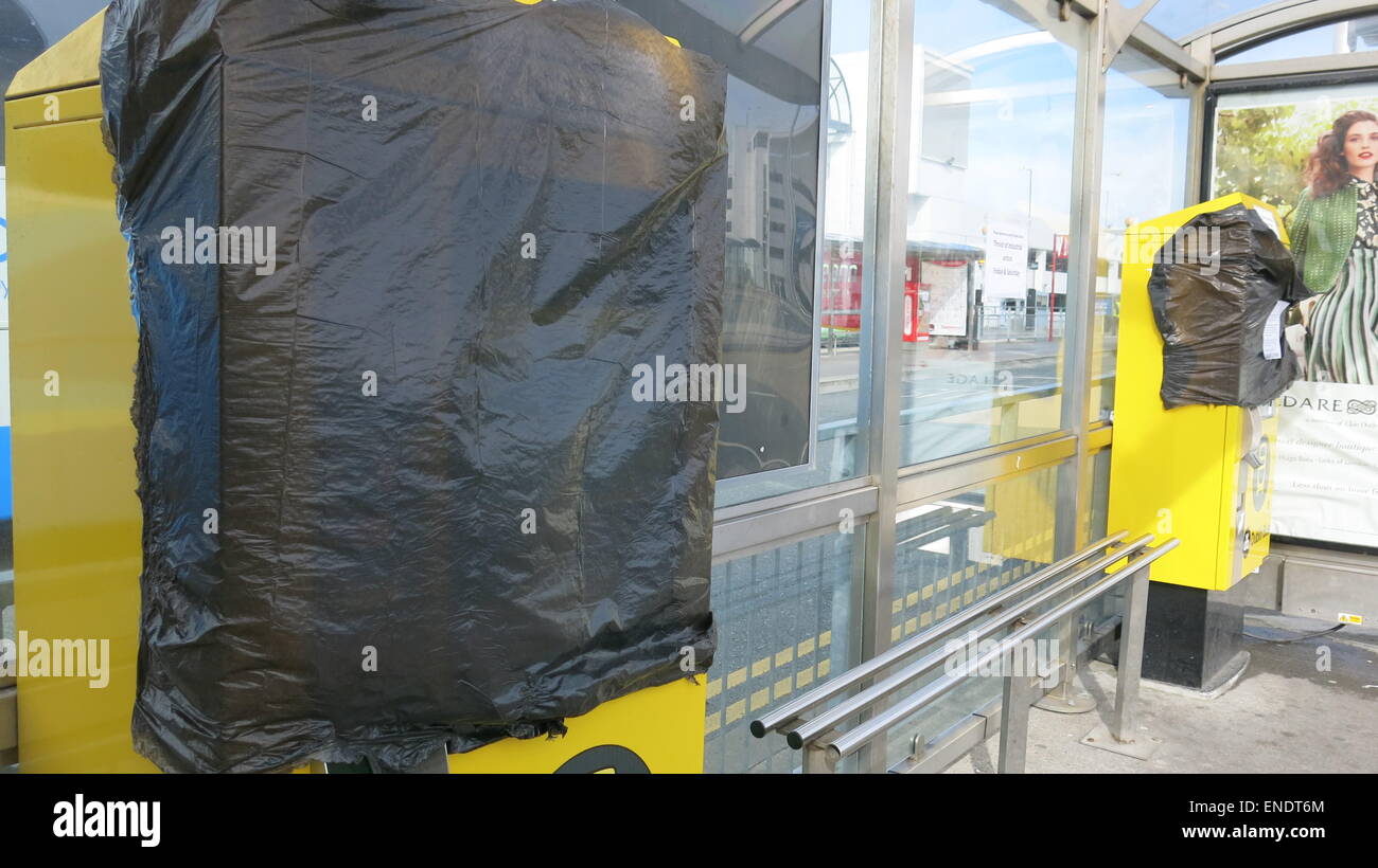 A plastic cover over a ticket machine at an empty bus stop at Dublin ...