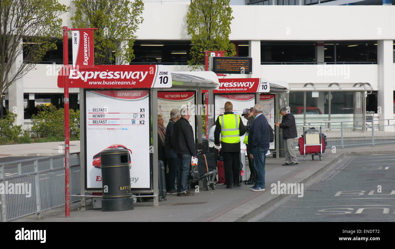 Commuters stand at a bus stop at Dublin airport during a day of ...