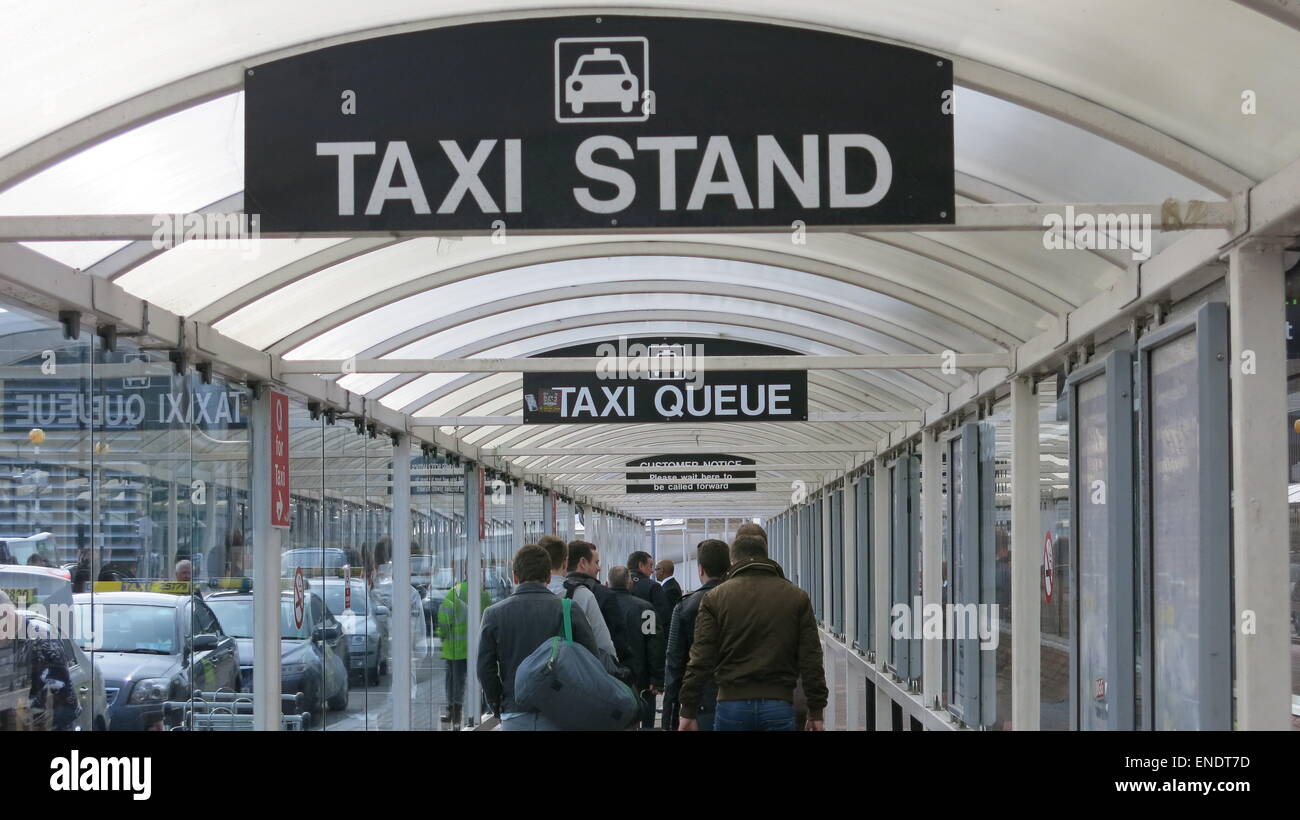 Tourists queue at a taxi rank at Dublin airport during a day of ...
